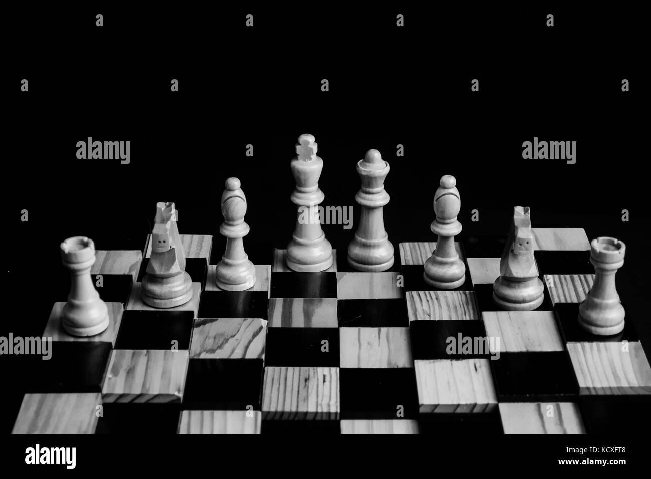 Low light photo of chess pieces and board Stock Photo - Alamy