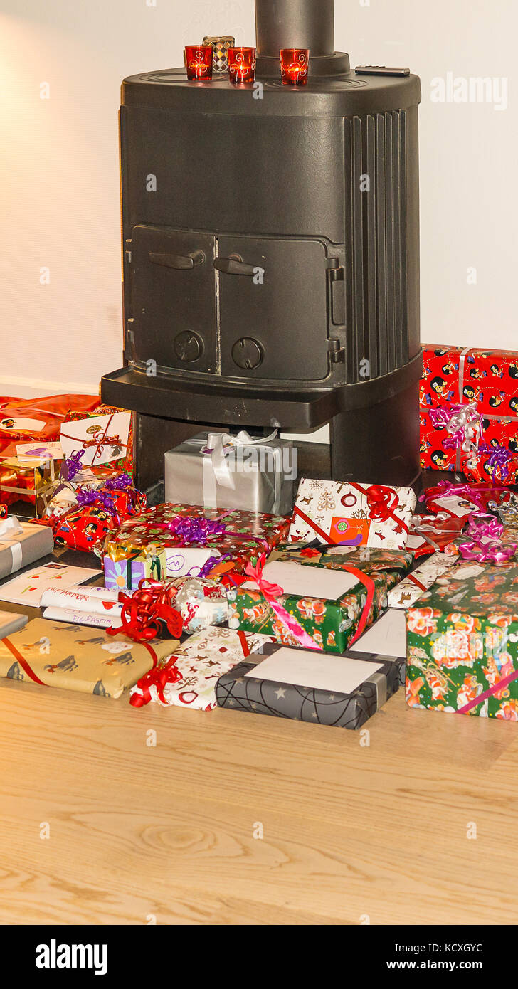 Colourful Christmas presents on the parquet floor in front of the ...