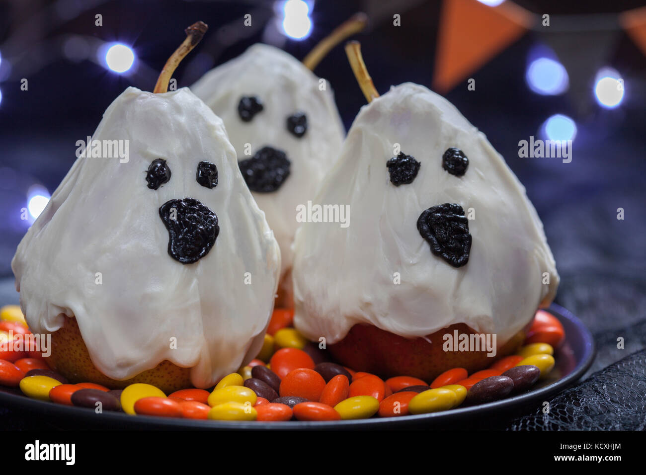 Three homemade creative Halloween candy pears or white chocolate ghosts ...