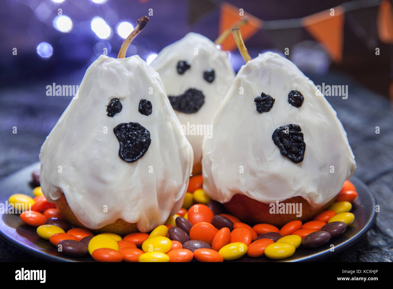 Three homemade creative Halloween candy pears or white chocolate ghosts ...