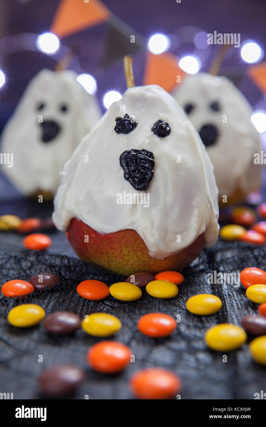Three homemade creative Halloween candy pears or white chocolate ghosts ...
