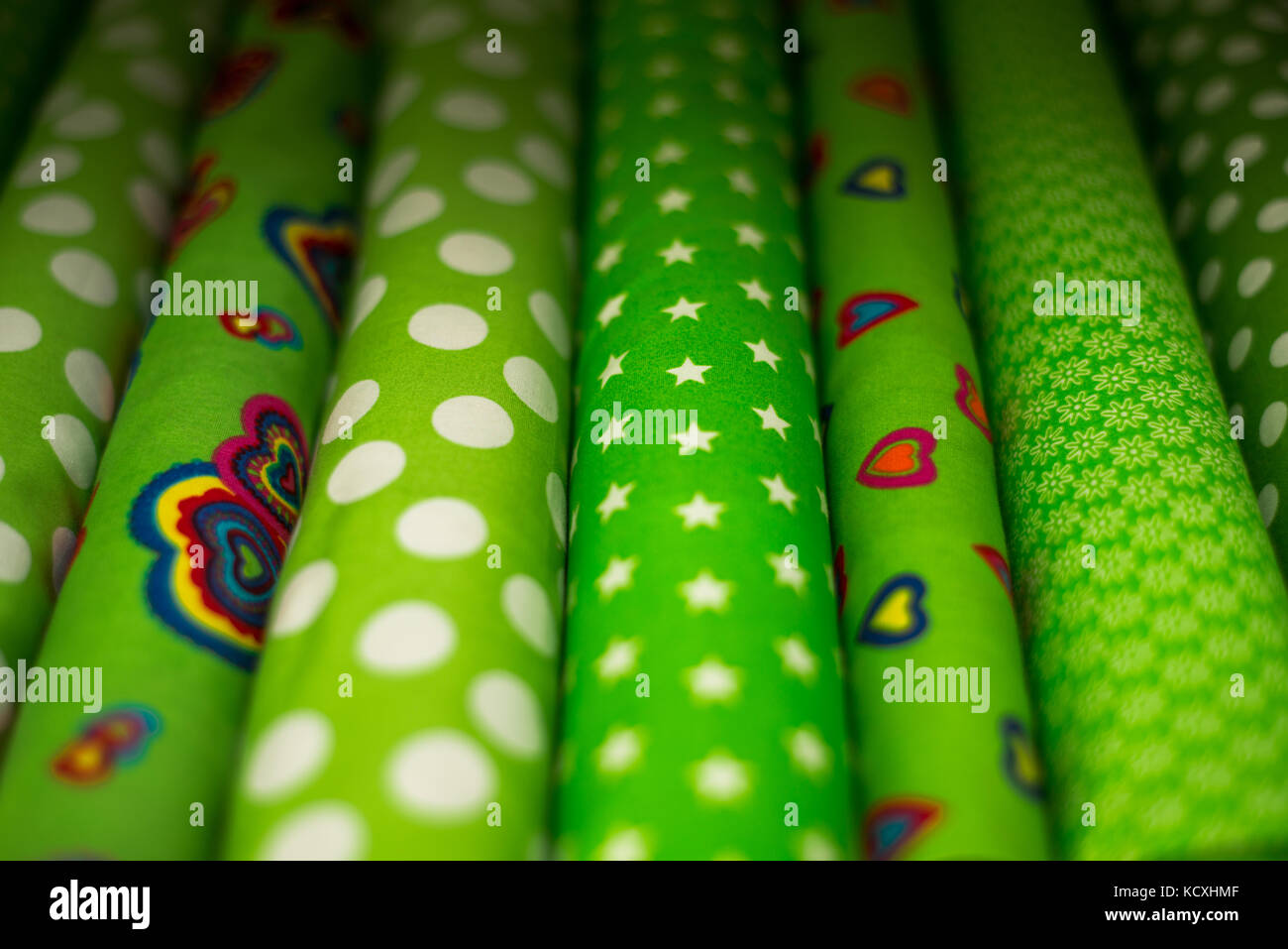 Stack of fabric green cloth rolls Stock Photo - Alamy