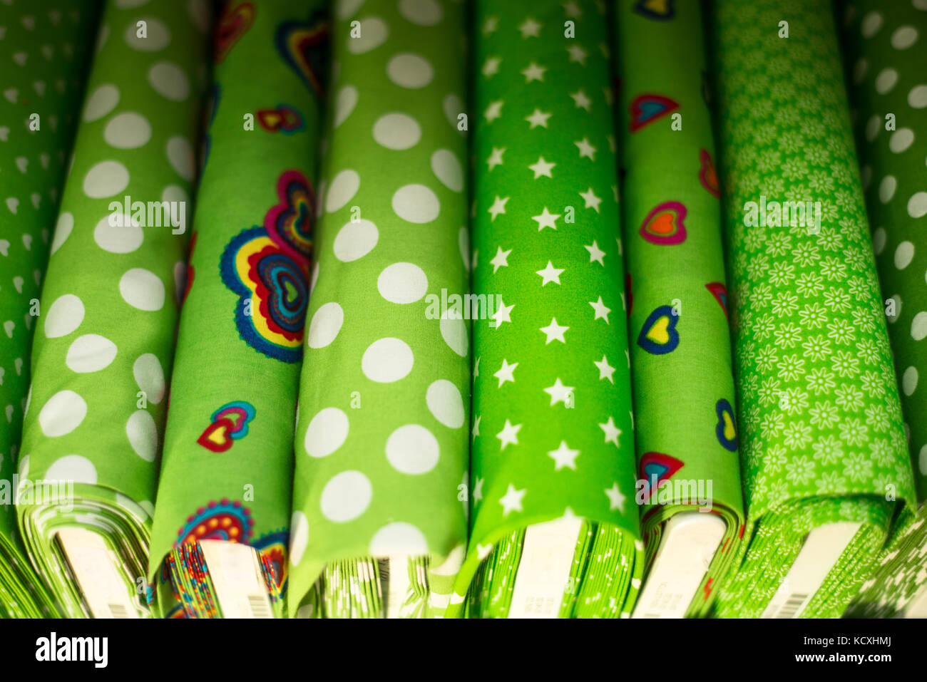 Stack of fabric green cloth rolls Stock Photo - Alamy