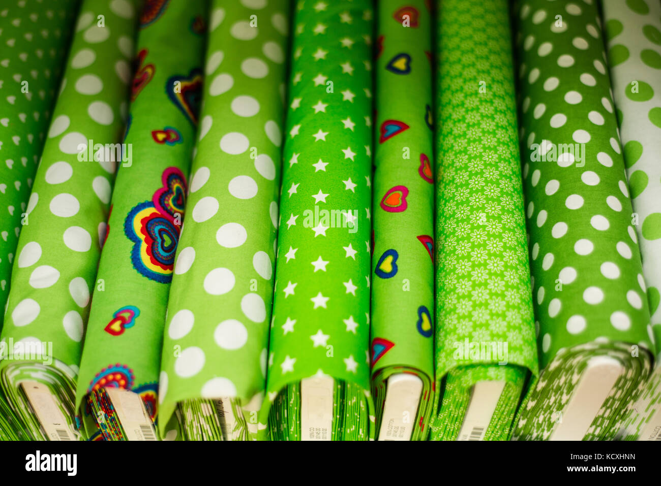 Stack of fabric green cloth rolls Stock Photo - Alamy