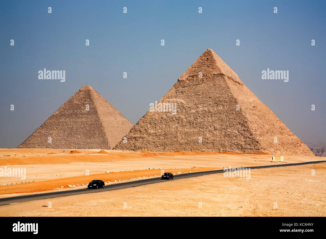 The Great Pyramids towering beyond Giza city Stock Photo - Alamy