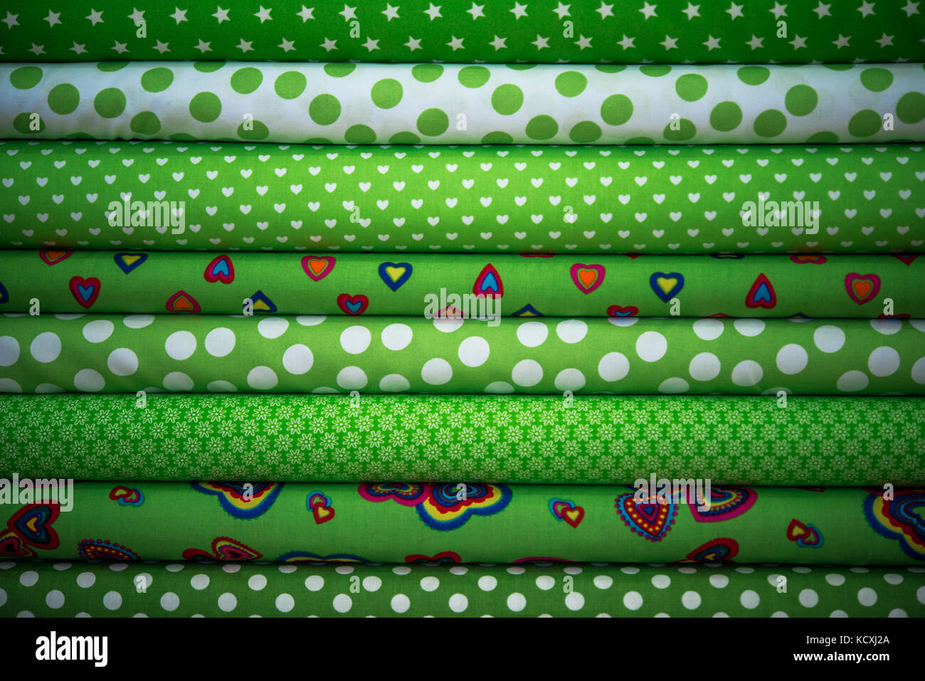 Stack of fabric green cloth rolls Stock Photo - Alamy