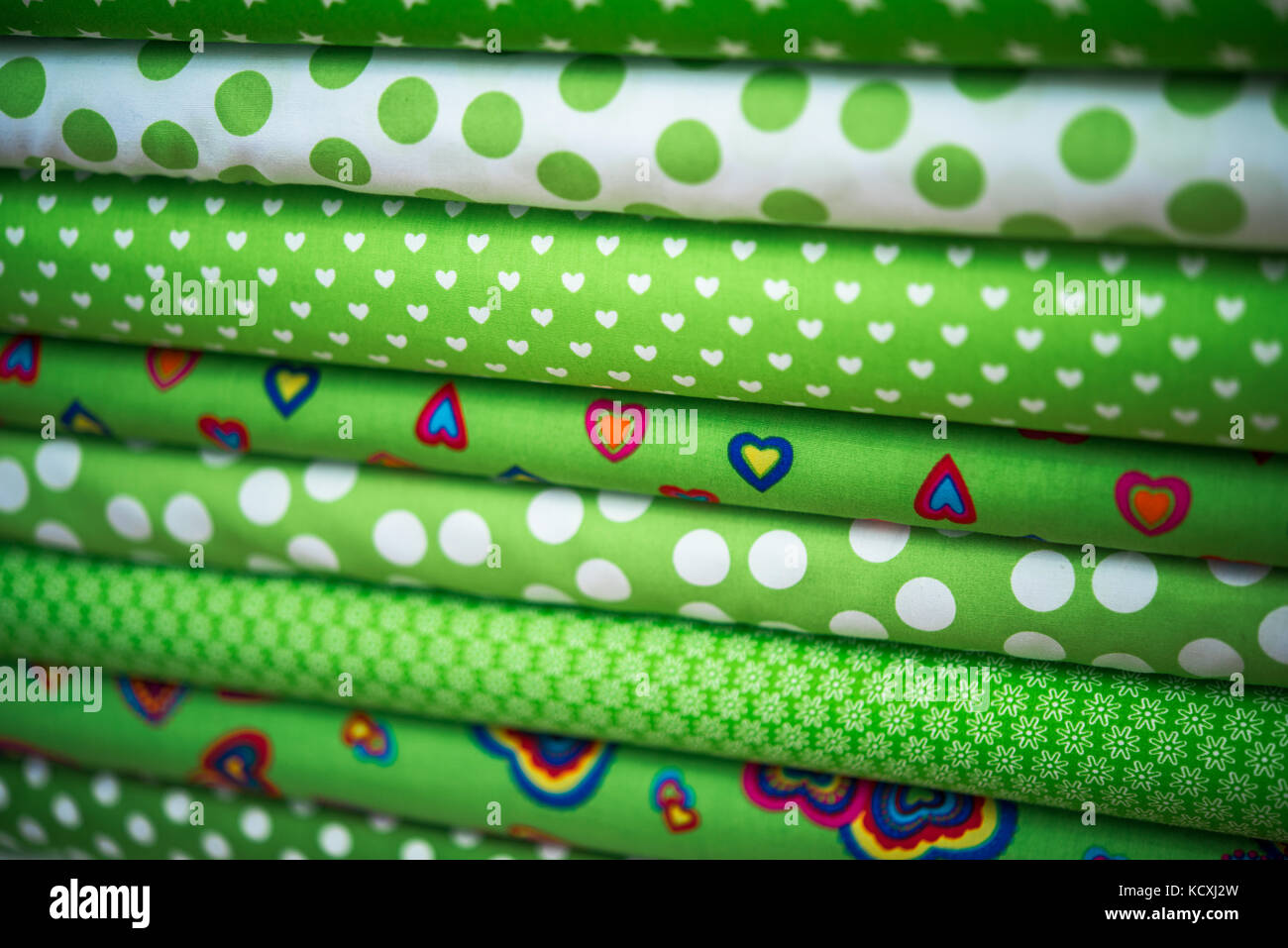 Stack of fabric green cloth rolls Stock Photo - Alamy