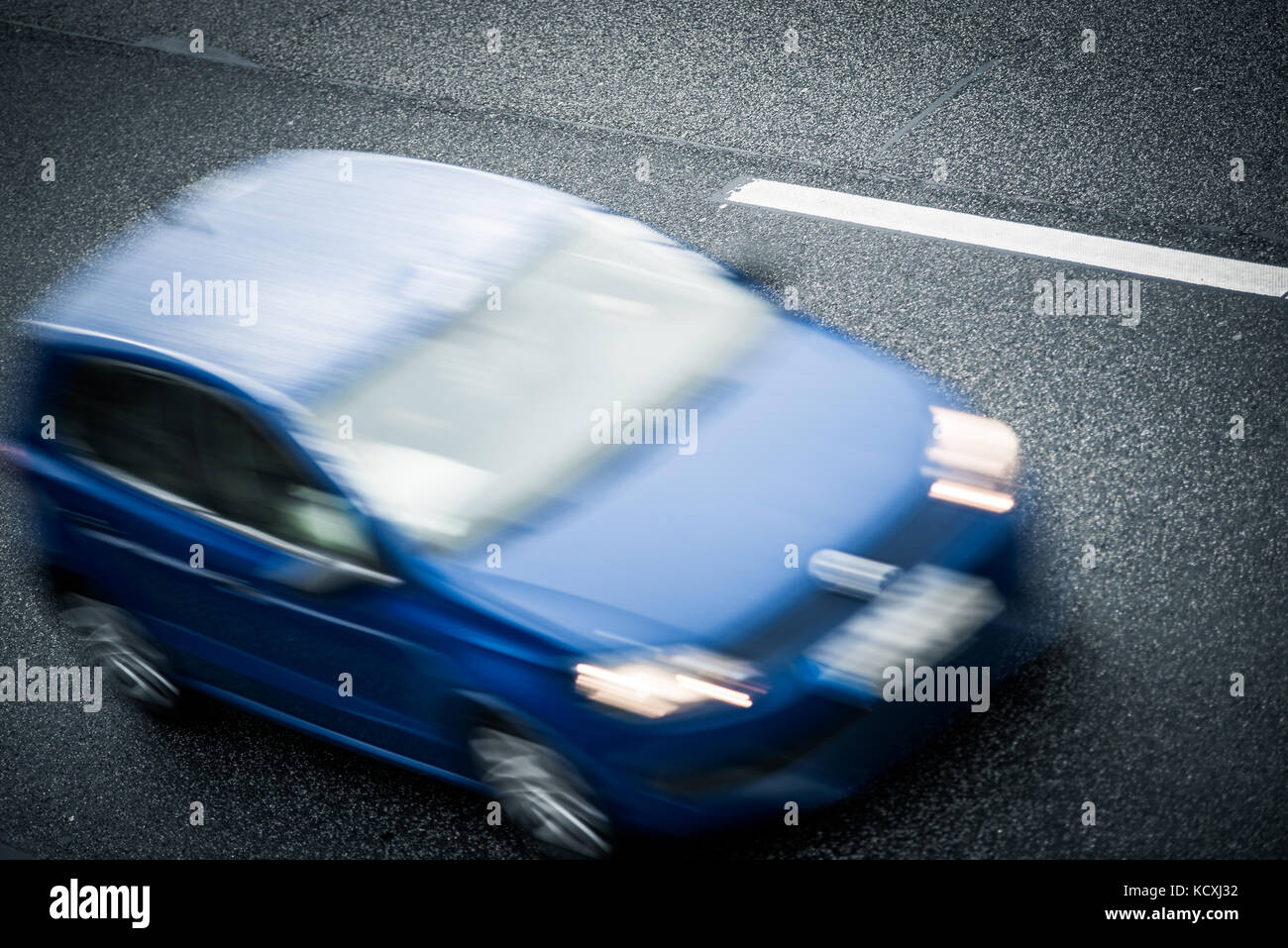 car driving fast on a wet highway Stock Photo - Alamy