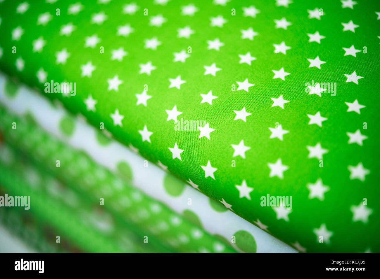Stack of fabric green cloth rolls Stock Photo - Alamy