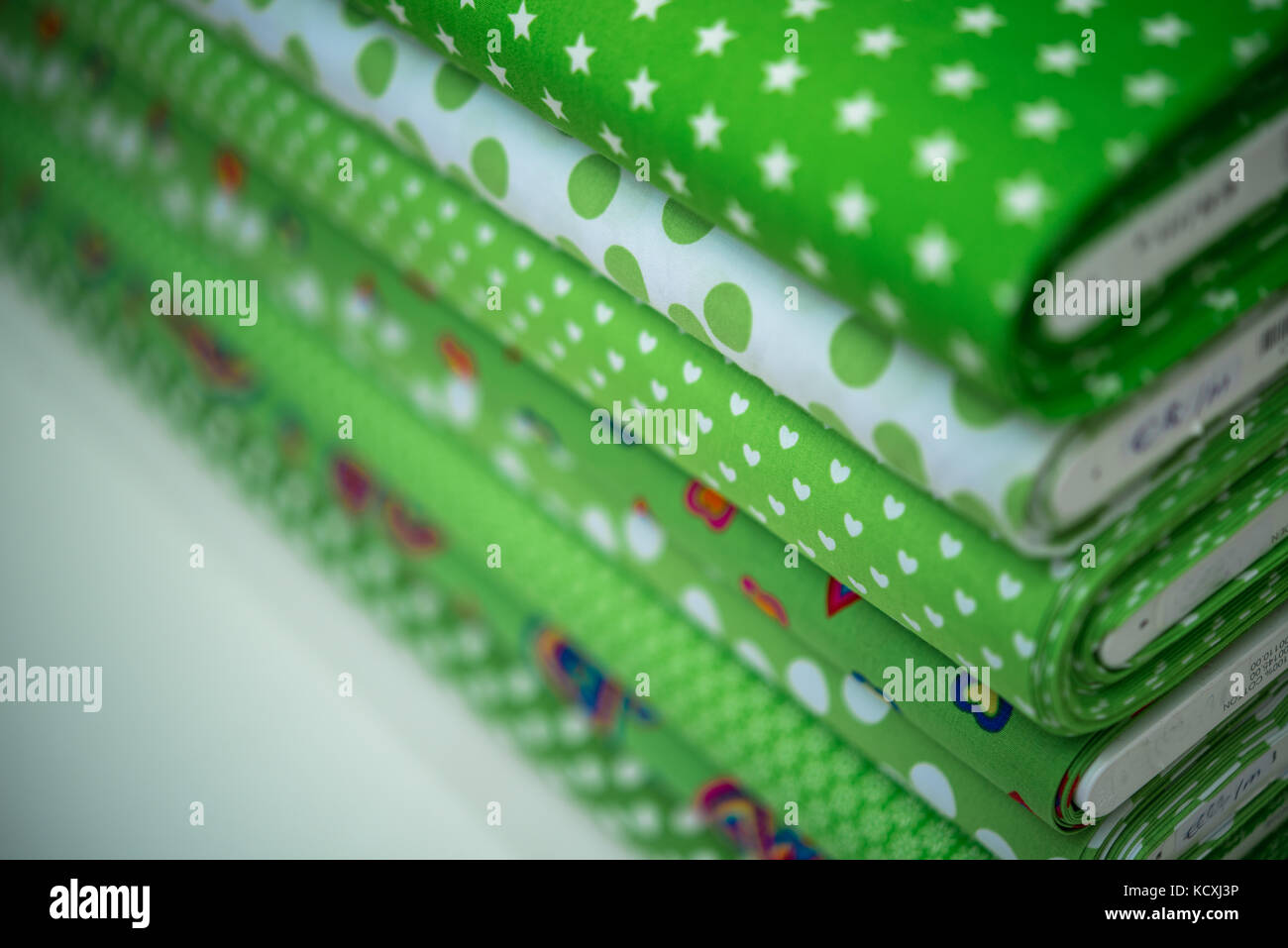 Stack of fabric green cloth rolls Stock Photo - Alamy