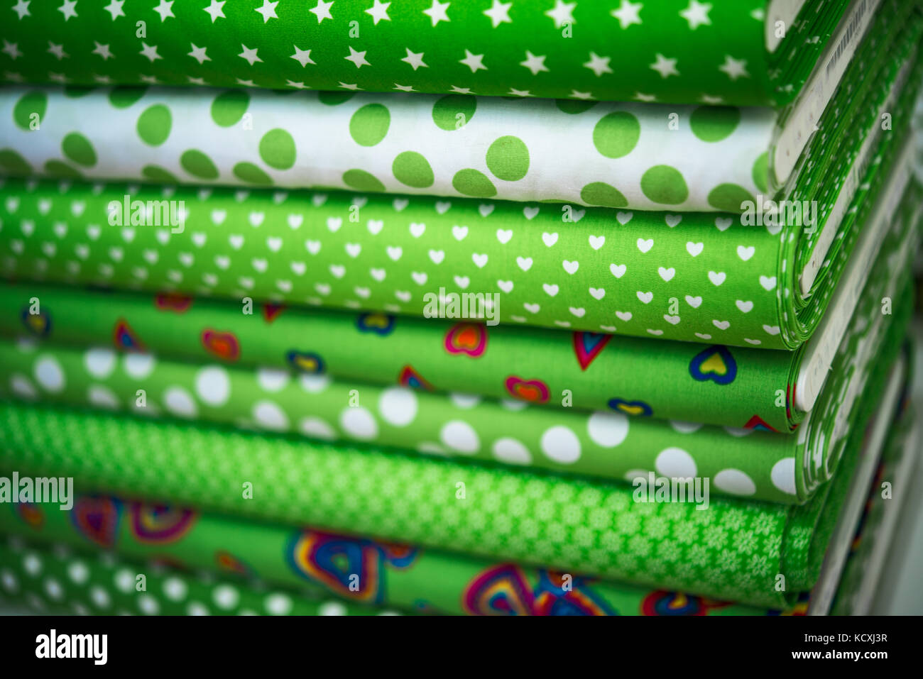 Stack of fabric green cloth rolls Stock Photo - Alamy