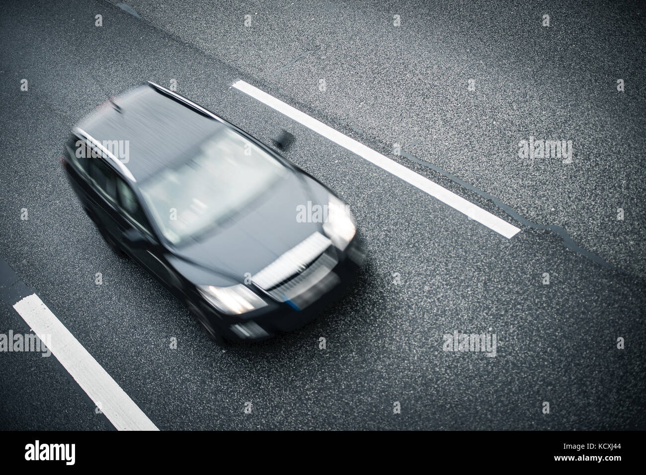 car driving fast on a wet highway Stock Photo - Alamy