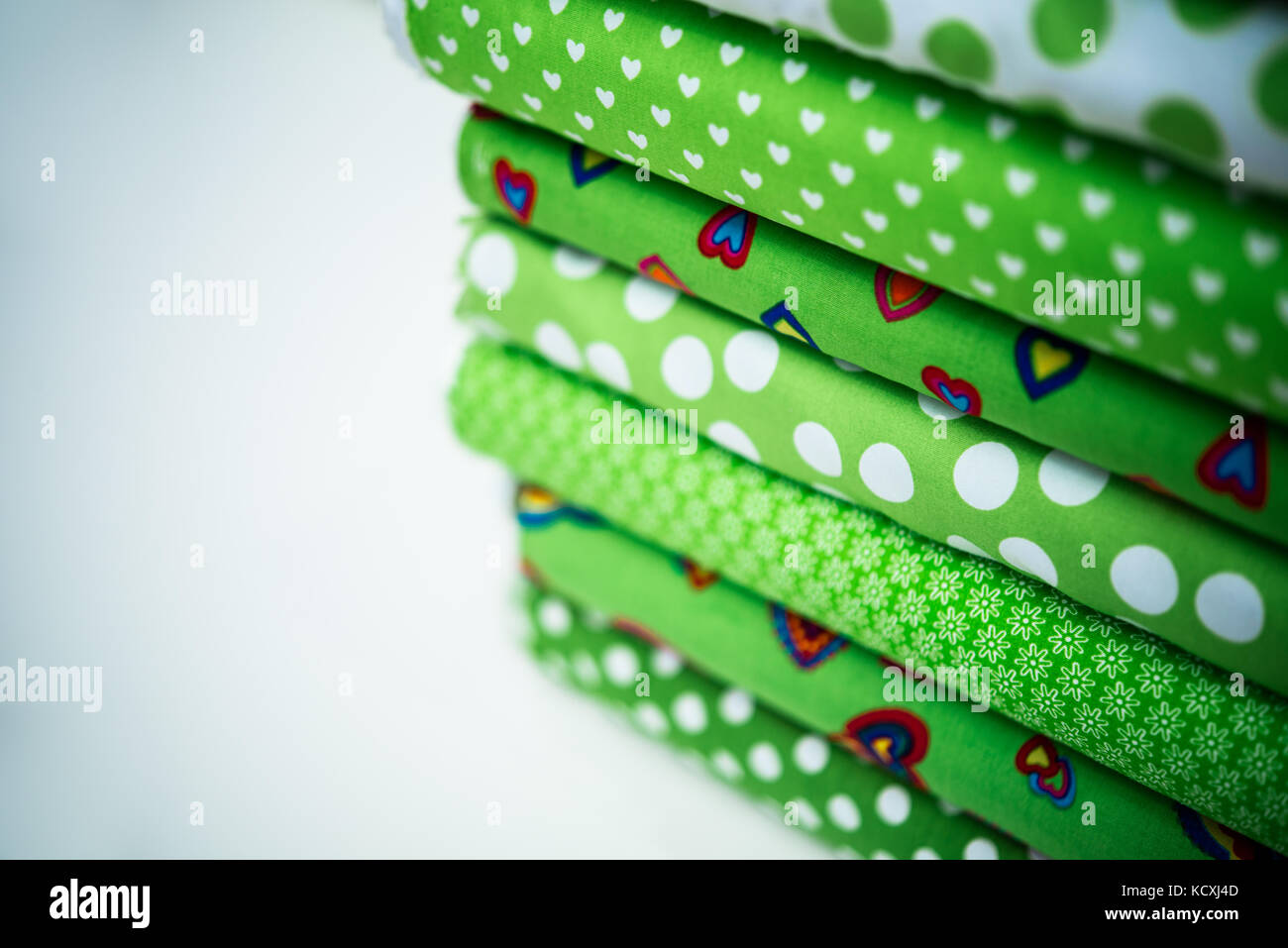 Stack of fabric green cloth rolls Stock Photo - Alamy
