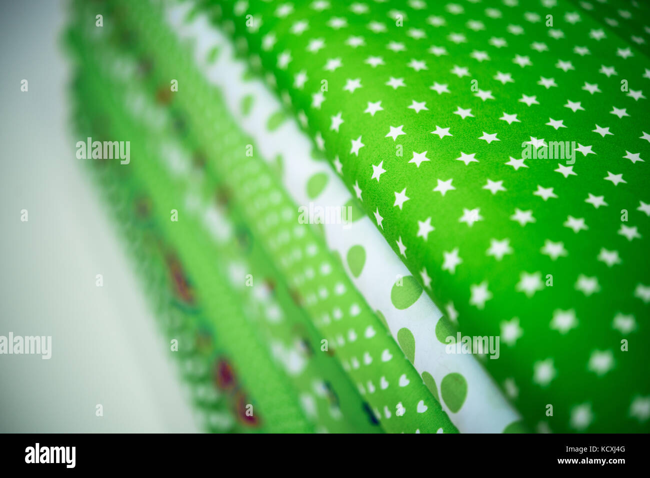 Stack of fabric green cloth rolls Stock Photo - Alamy