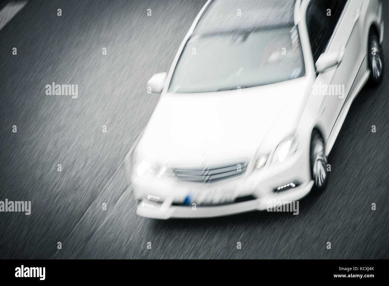 car driving fast on a wet highway Stock Photo - Alamy