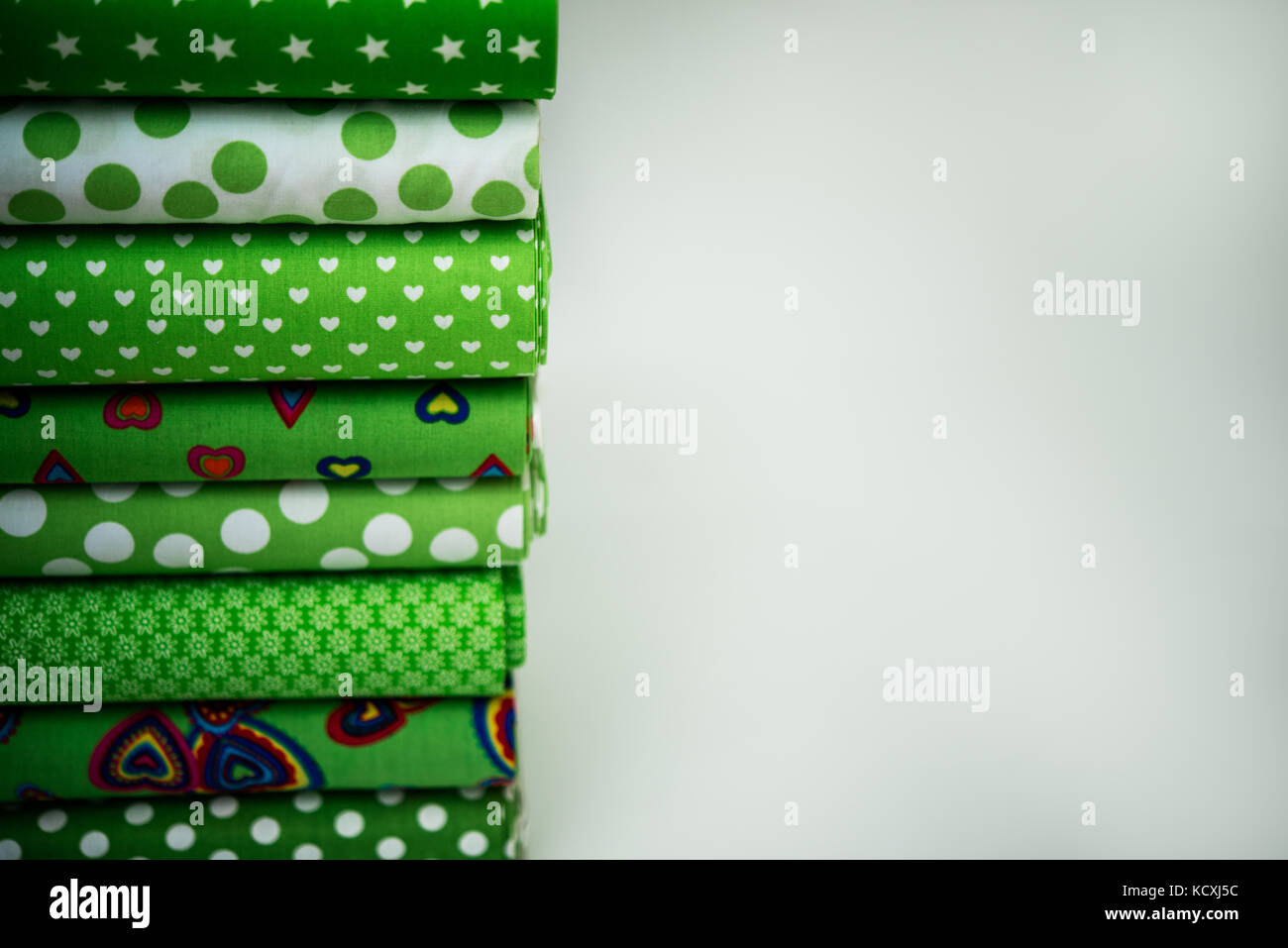Stack of fabric green cloth rolls Stock Photo - Alamy