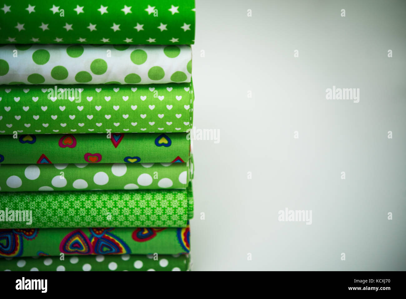 Stack of fabric green cloth rolls Stock Photo - Alamy