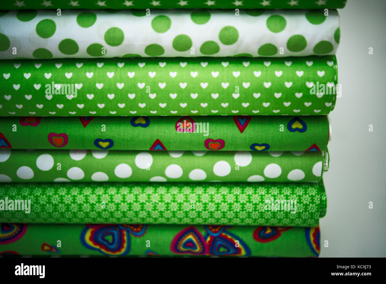 Stack of fabric green cloth rolls Stock Photo - Alamy
