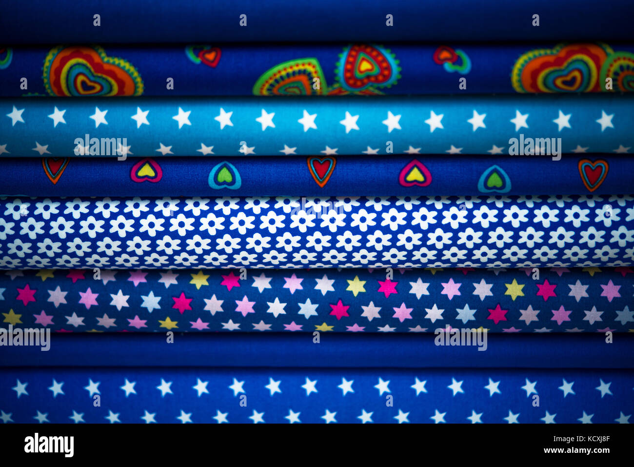 Stack of fabric blue cloth rolls Stock Photo - Alamy