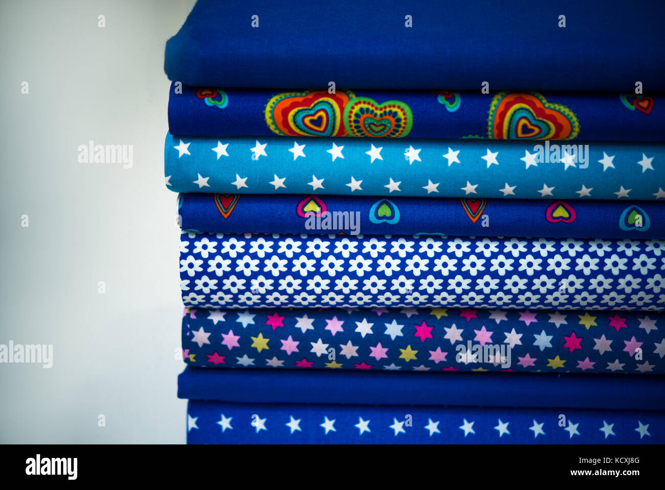Stack of fabric blue cloth rolls Stock Photo - Alamy