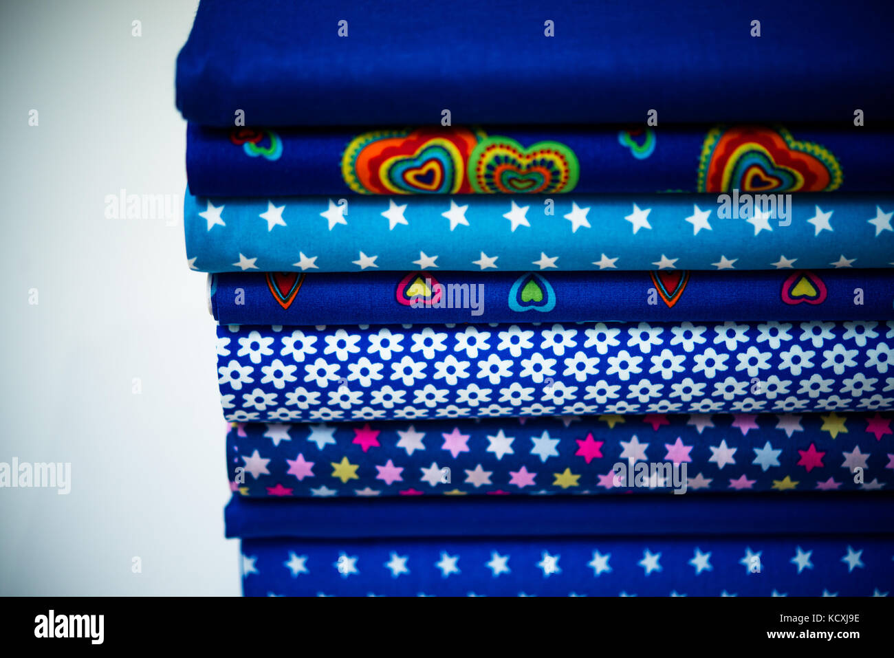 Stack of fabric blue cloth rolls Stock Photo - Alamy