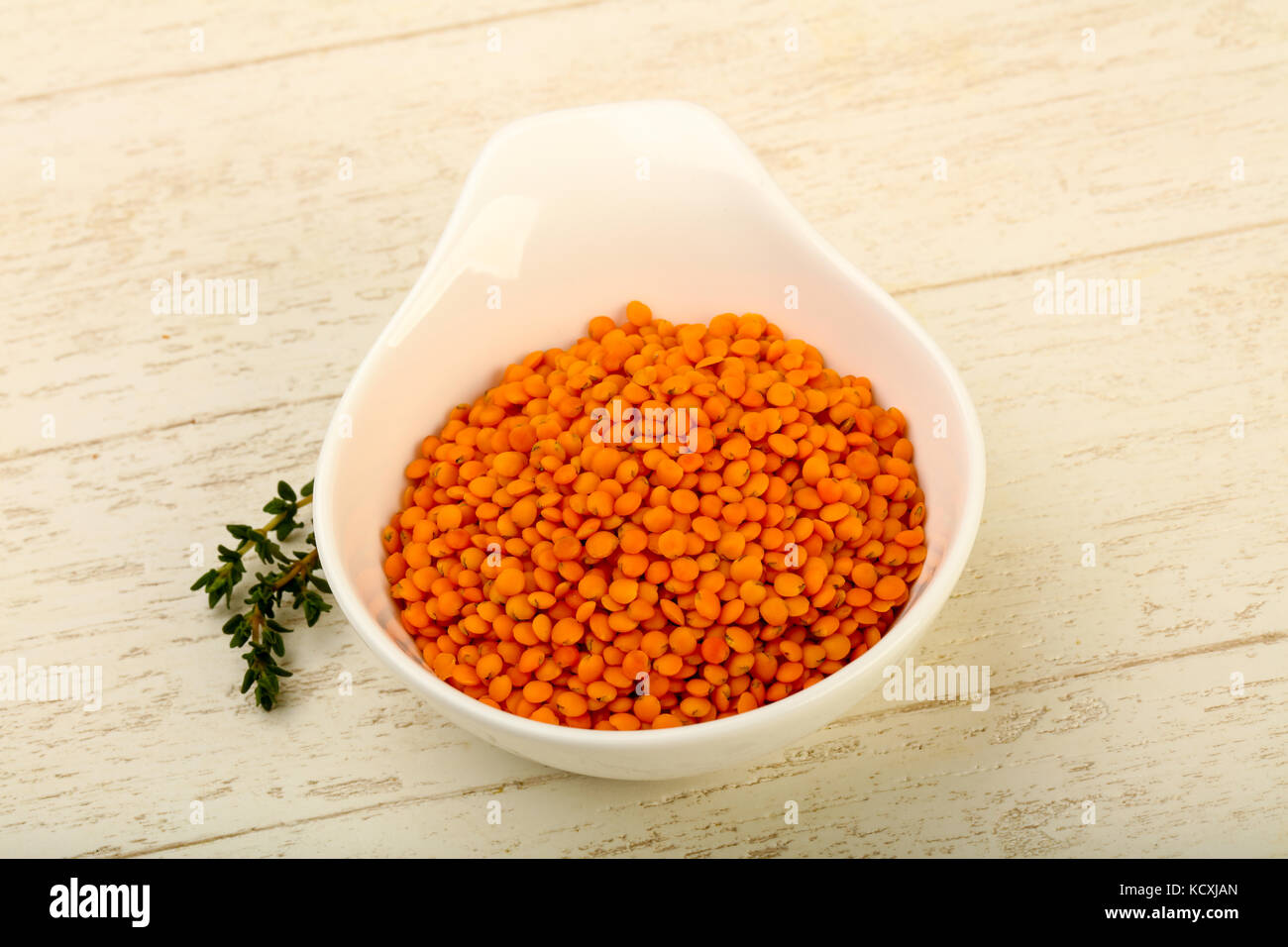 Orange lentil in the bowl over wooden background Stock Photo - Alamy