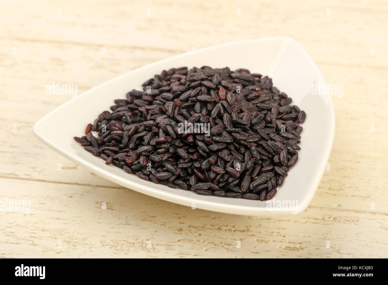 Black wild rice in the bowl over wooden background Stock Photo - Alamy