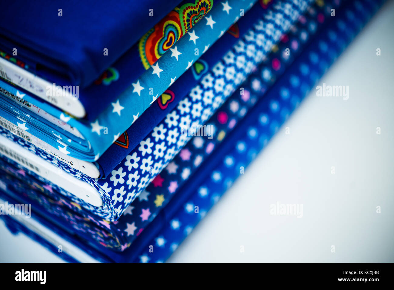 Stack of fabric blue cloth rolls Stock Photo - Alamy