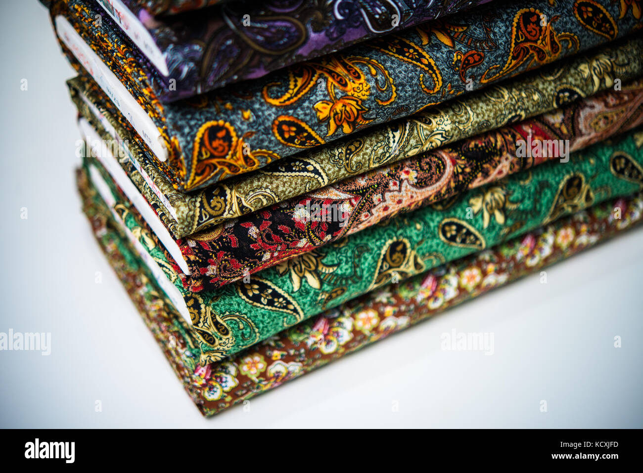 Stack of fabric paisley cloth rolls Stock Photo - Alamy