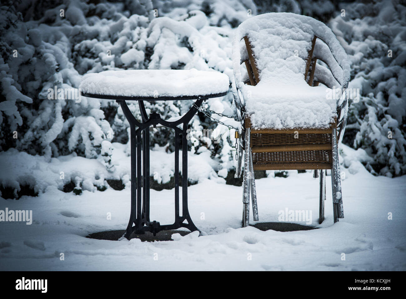 Stack of chairs and table in winter cafe snow Stock Photo - Alamy