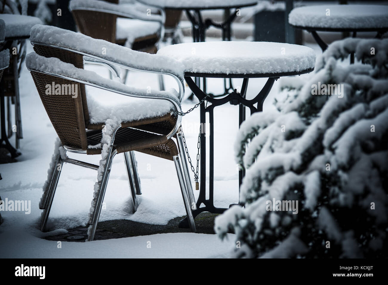 Stack of chairs and table in winter cafe snow Stock Photo - Alamy