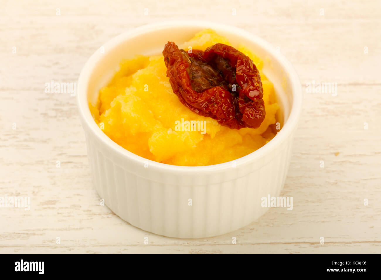 Polenta with dry tomato Stock Photo - Alamy