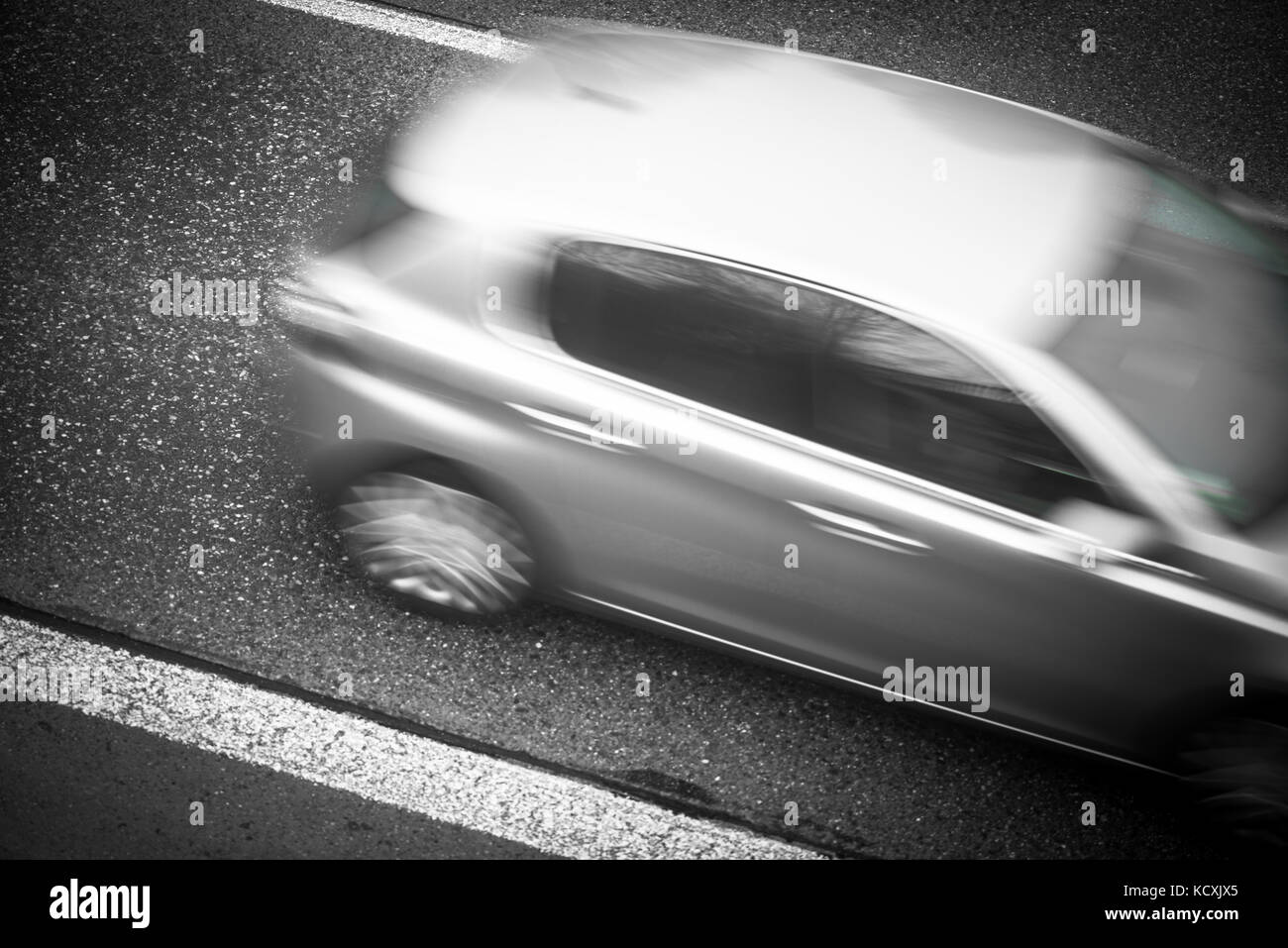 Topshot of a car on a highway driving fast Stock Photo - Alamy