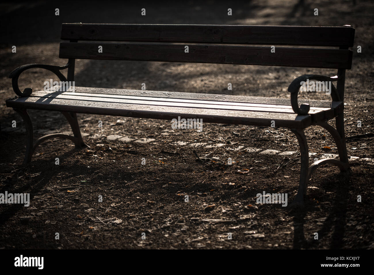 Solemn bench in shadow with sunlight in autumn and frost Stock Photo ...