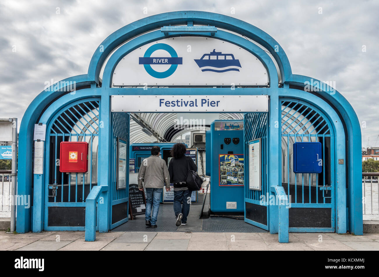 A couple at the Festival Pier, ferry terminal entrance, which crosses ...