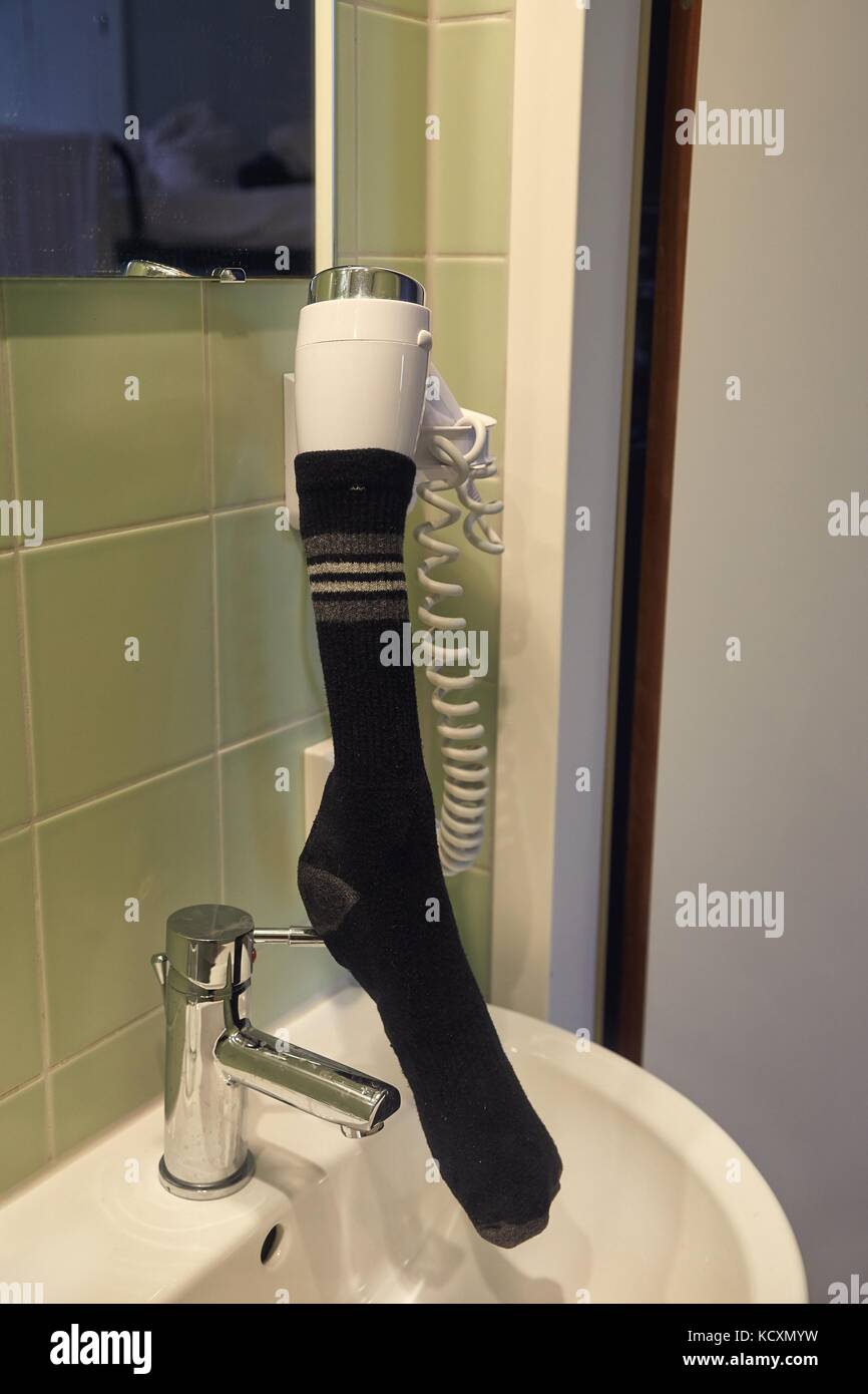 Drying sock in a hairdryer Stock Photo - Alamy