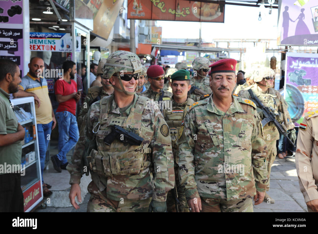 U.S. and Iraqi military leaders walk through a Mosul market after the ...