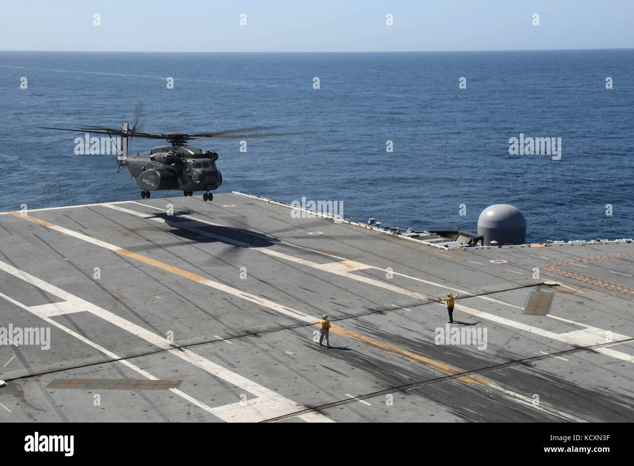 Helicopter landing on aircraft carrier Stock Photo - Alamy