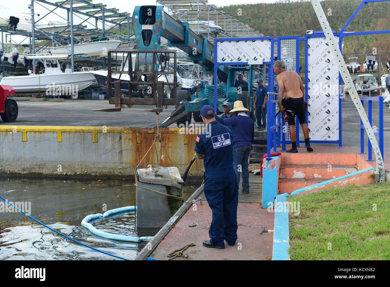 Petty Officer 1st Class Jon Faulkner oversees the removal of a diesel ...
