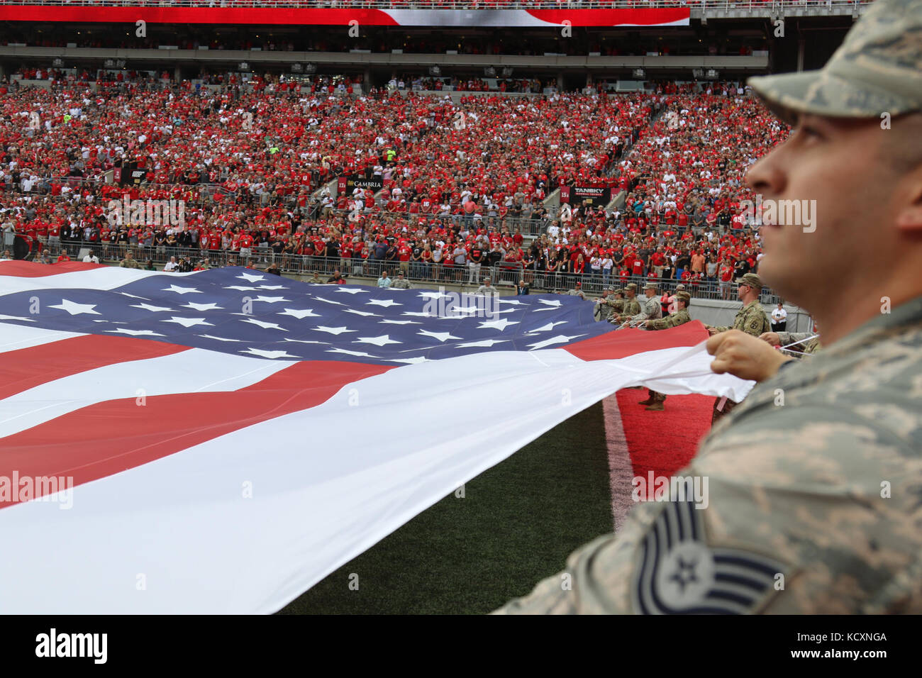 Ohio National Guard members hold a large American flag during pregame ...