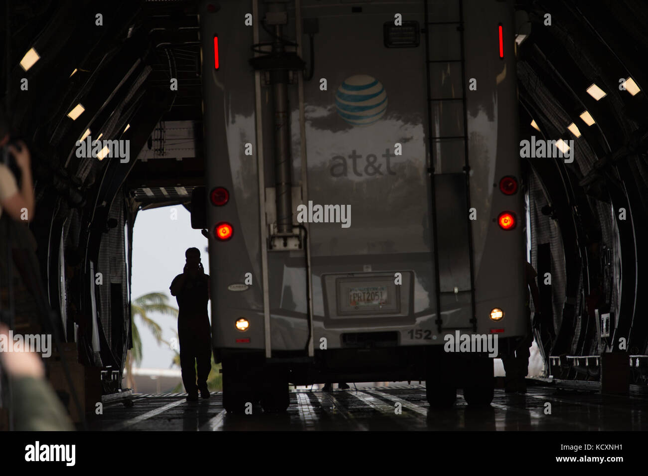 An AT&T mobile telecommunications tower is guided out from a C-5M Super ...