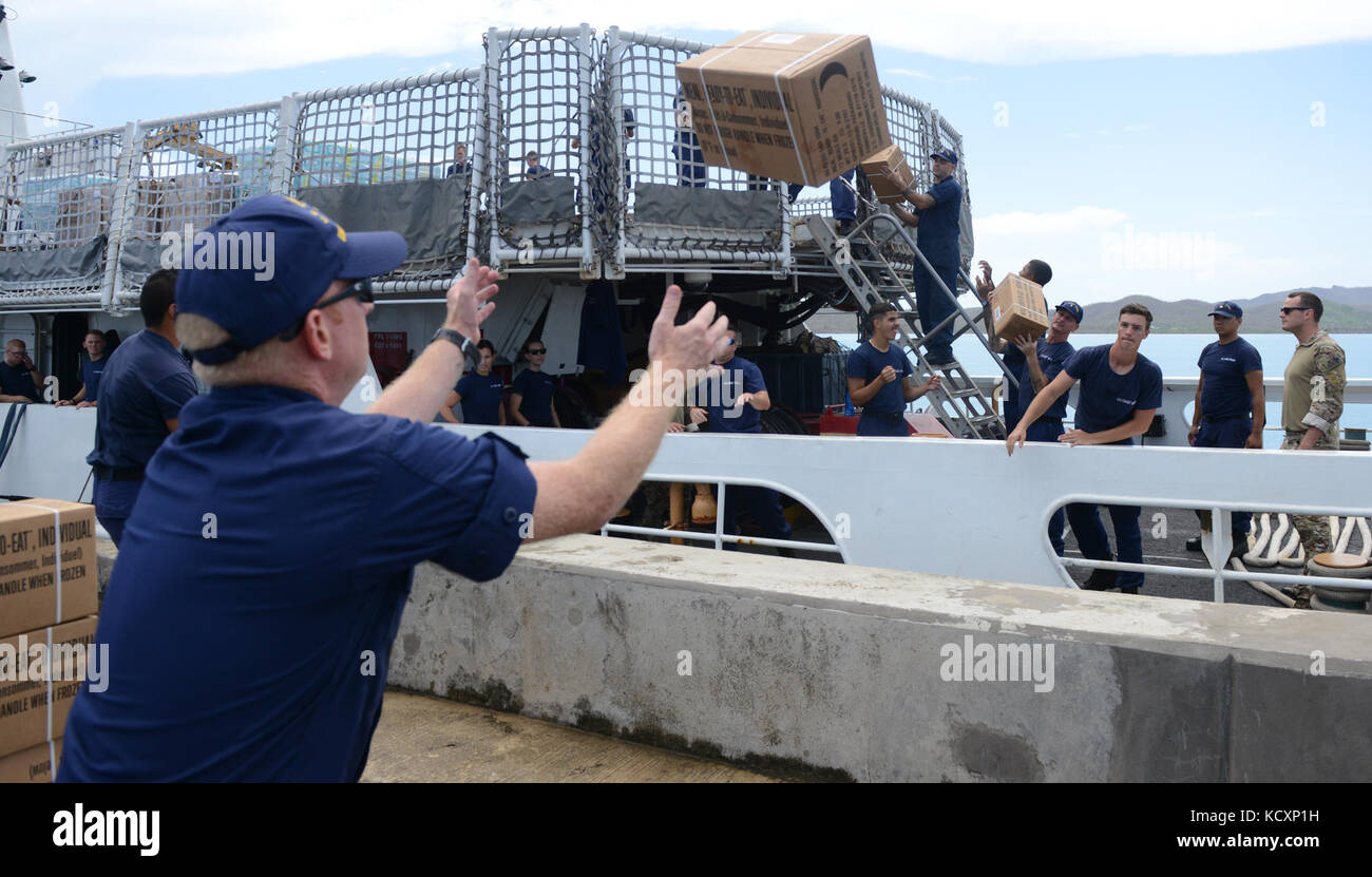 Crewmembers from the Coast Guard Cutter Venturous deliver approximately ...