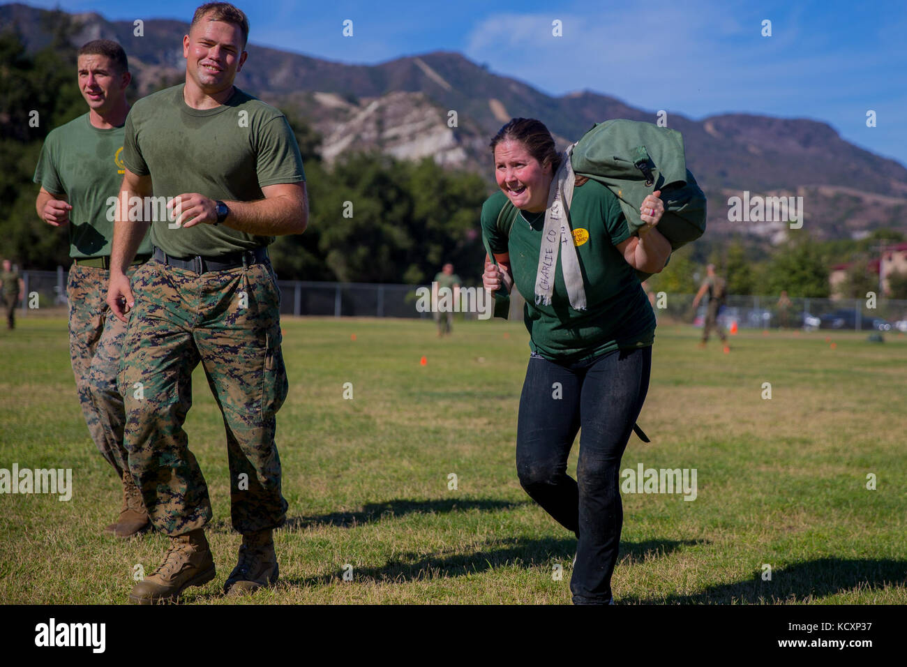 Makenzie Smith, a U.S. Marine spouse, runs with a sea bag during Jane ...