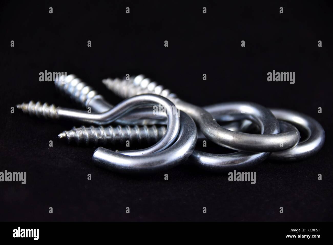 stainless steel hook with conical thread, a group of abstract metal ...