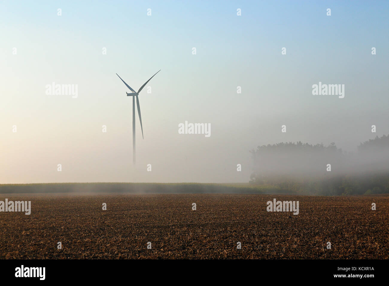 Wind turbine in the mist at dawn in southern Ontario Stock Photo - Alamy