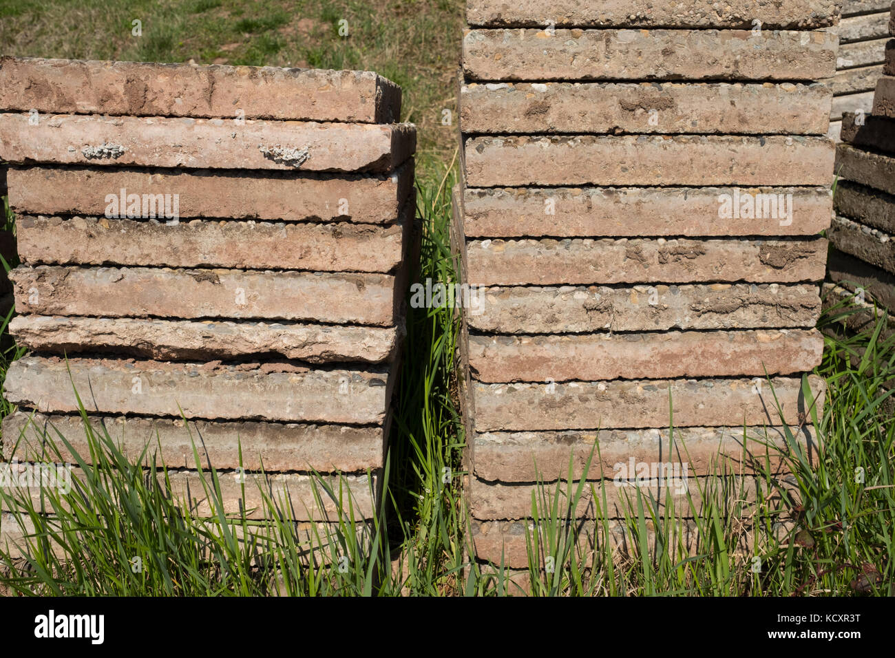 Stack of washing concrete slabs on a green meadow Stock Photo - Alamy