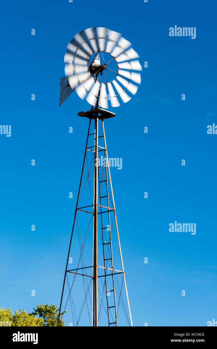 spinning windmill against blue sky Stock Photo - Alamy