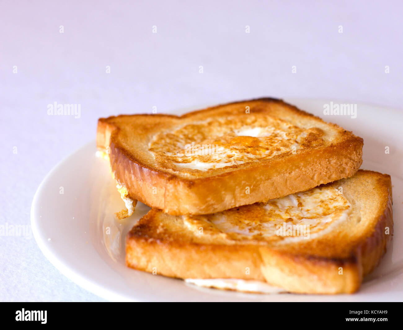 Toasted bread fried with egg inside Stock Photo - Alamy