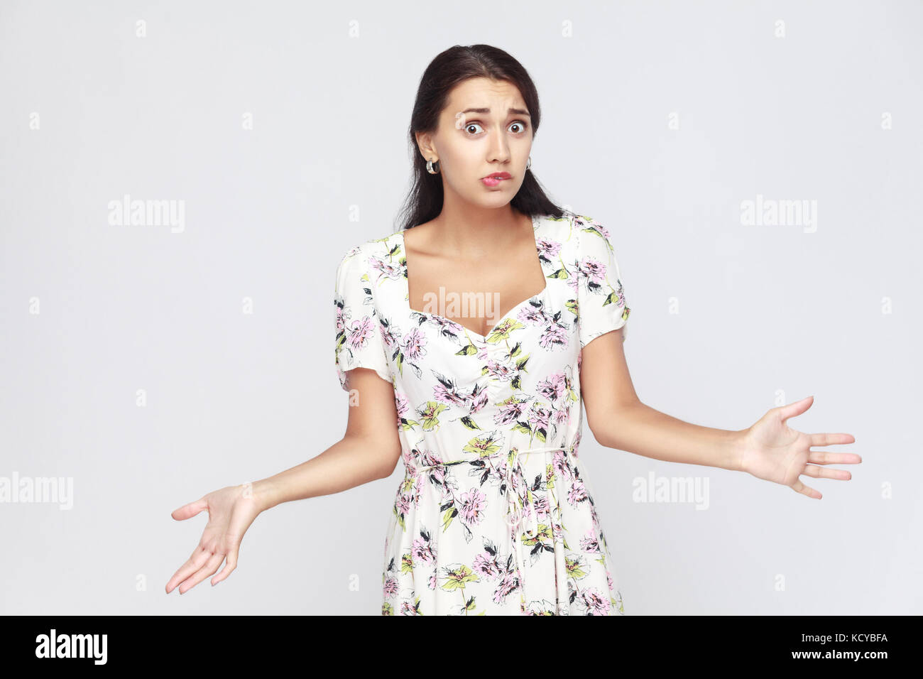 I dont know. Confused woman in flower dress. Negative human emotions ...