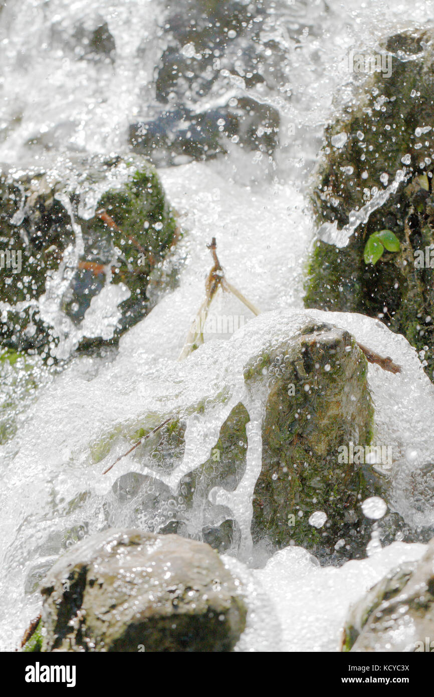 WATER TORRENT IN WATERFALL BREAKING IN THE ROCKS Stock Photo - Alamy